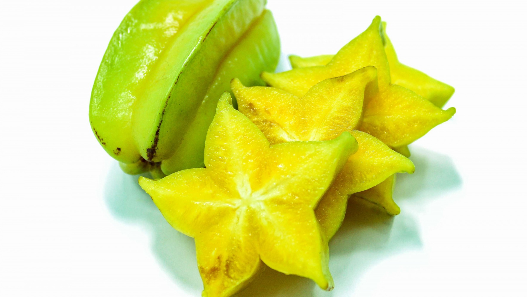 Originating in Southeast Asia, the star fruit is yellow or green in ...